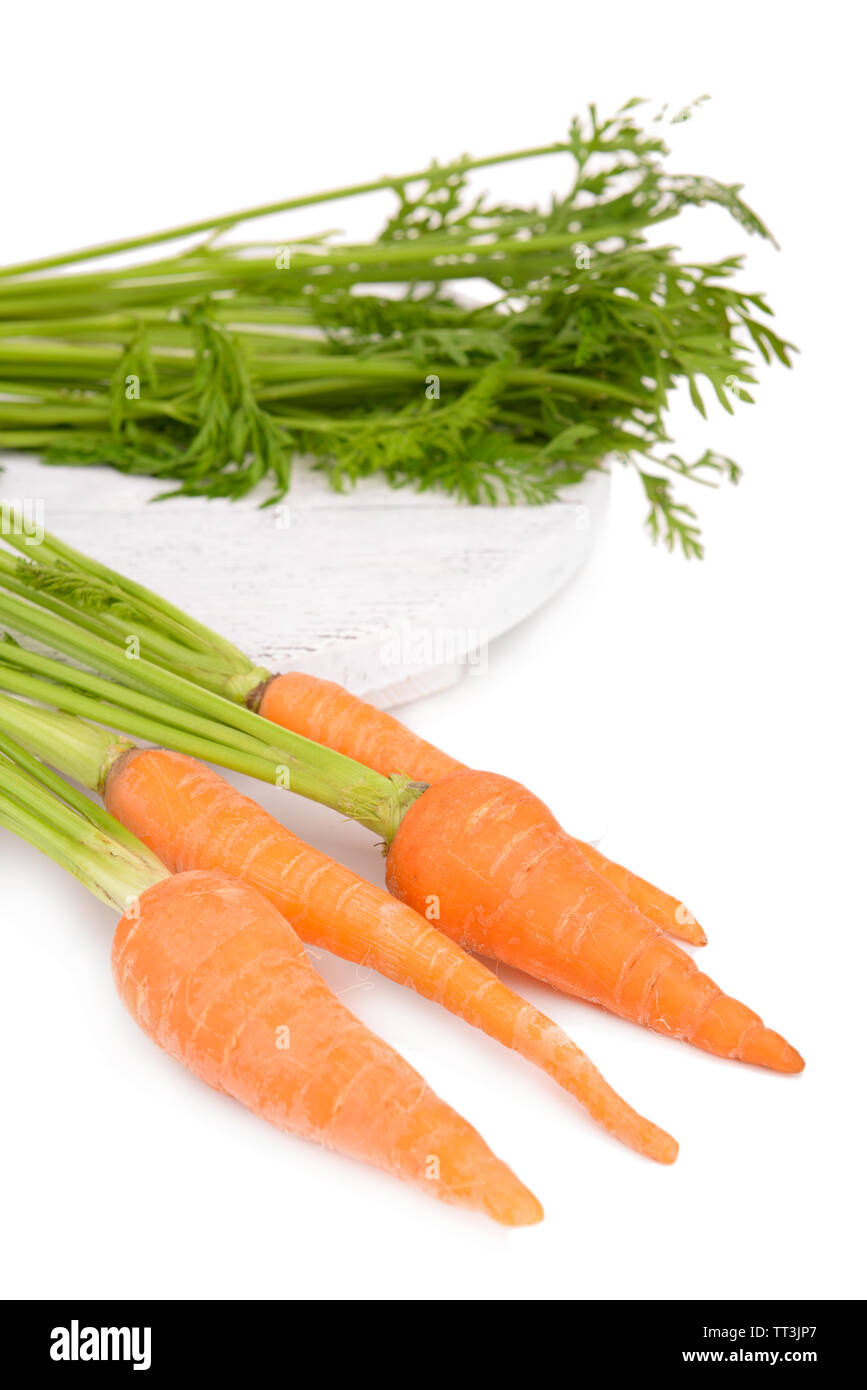 Fresh carrot on wooden stand isolated on white Stock Photo - Alamy