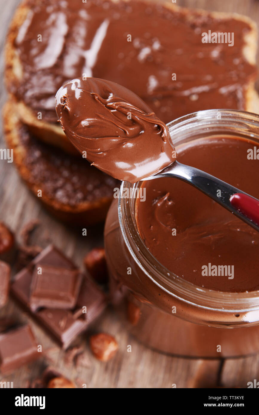 Sweet chocolate cream in jar on table close-up Stock Photo - Alamy