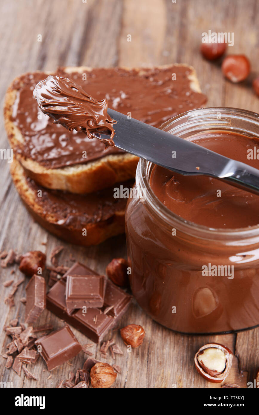 Sweet chocolate cream in jar on table close-up Stock Photo - Alamy