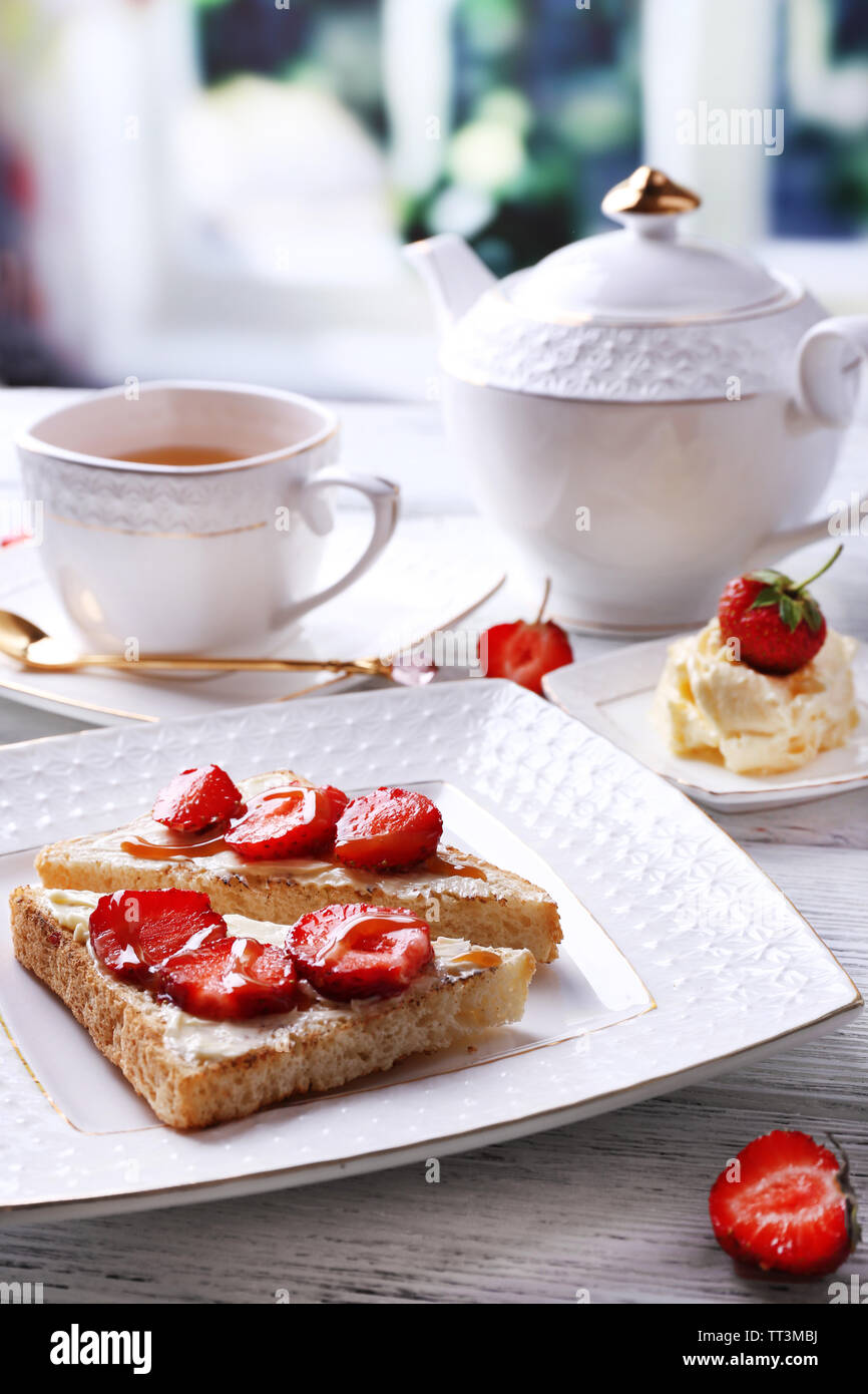 Fresh toast with homemade butter and fresh strawberry on plate on ...