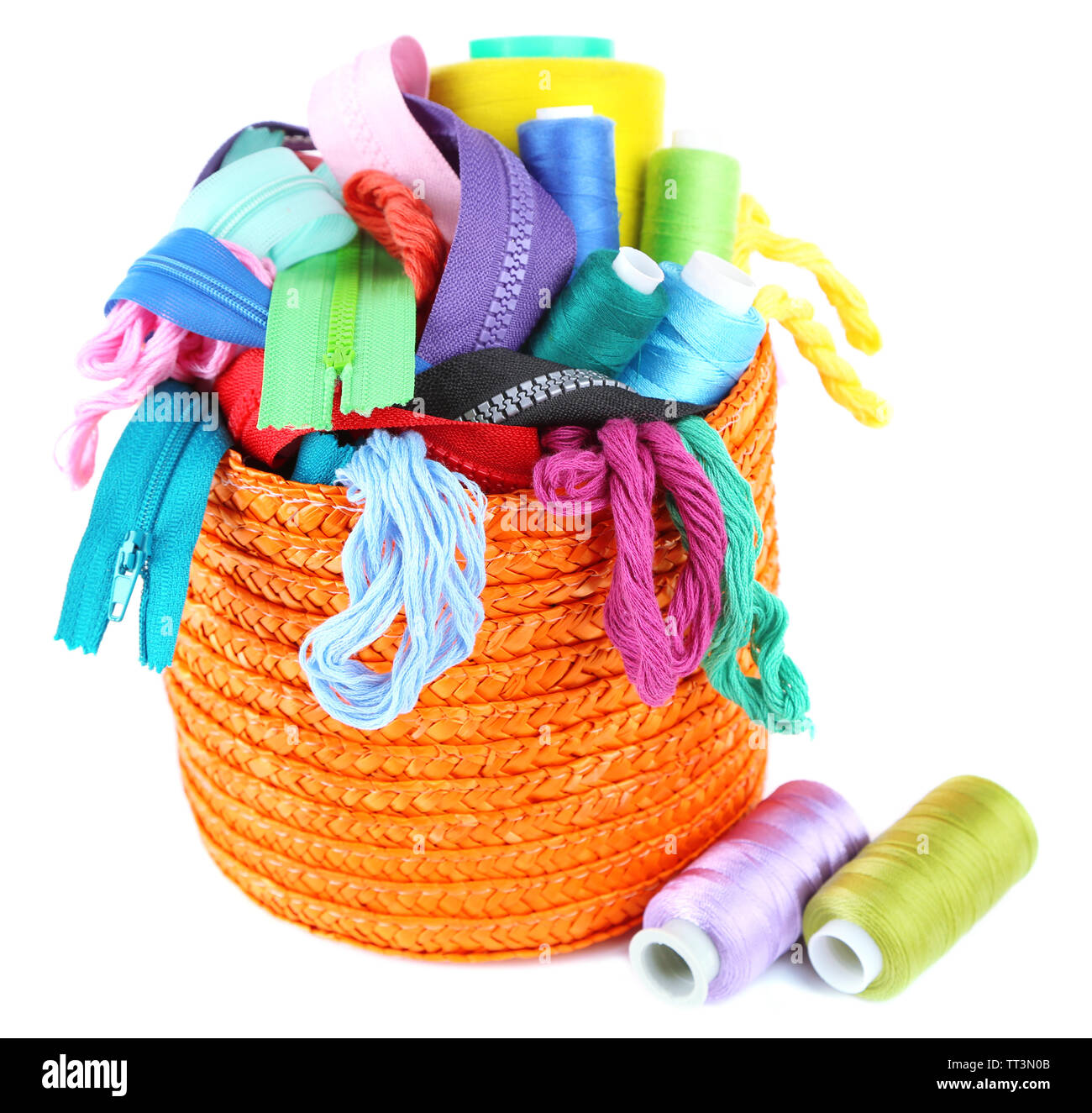 Round orange box full of multicoloured threads and everything necessary ...