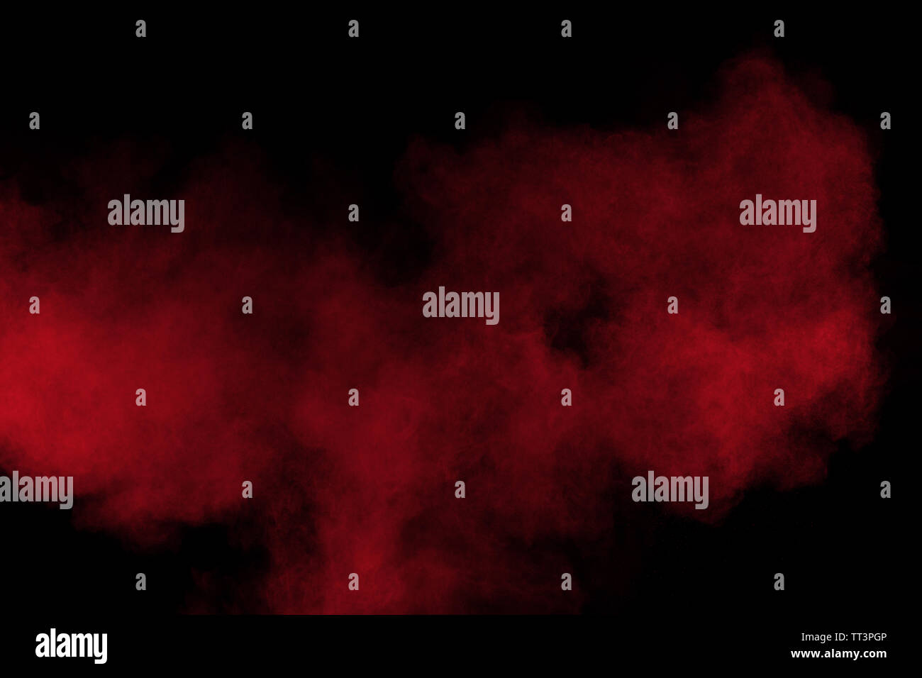 Red color powder explosion on black background. Freeze motion of red ...