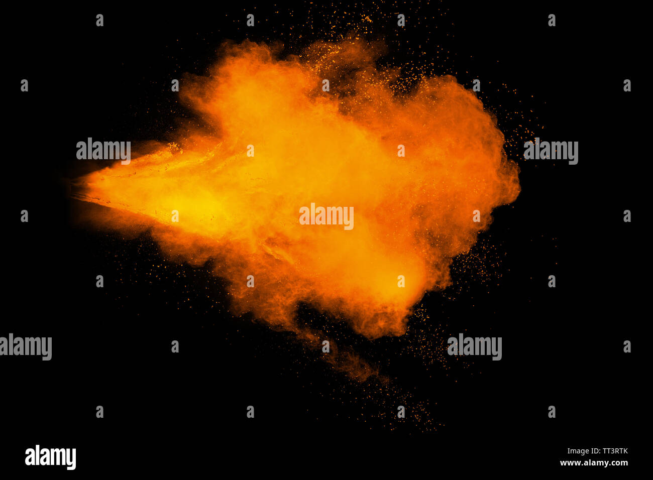Abstract yellow orange powder explosion on black background. Freeze ...