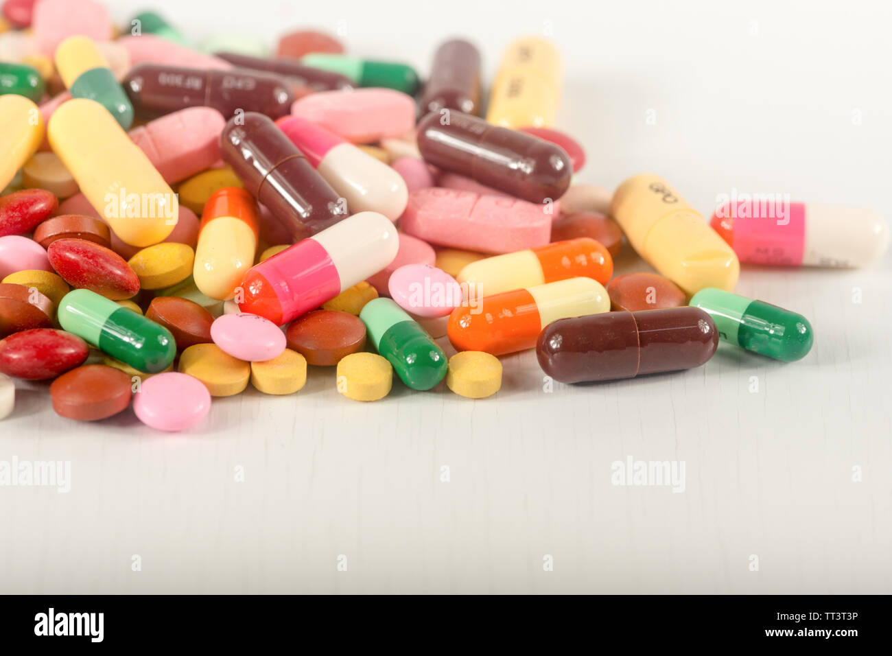 Colorful pills splatter on white background.The different tablets and ...
