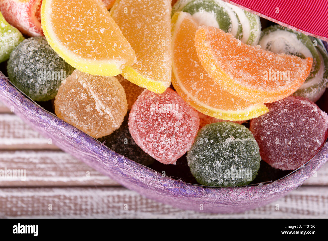 Present box with sweets on wooden background Stock Photo - Alamy