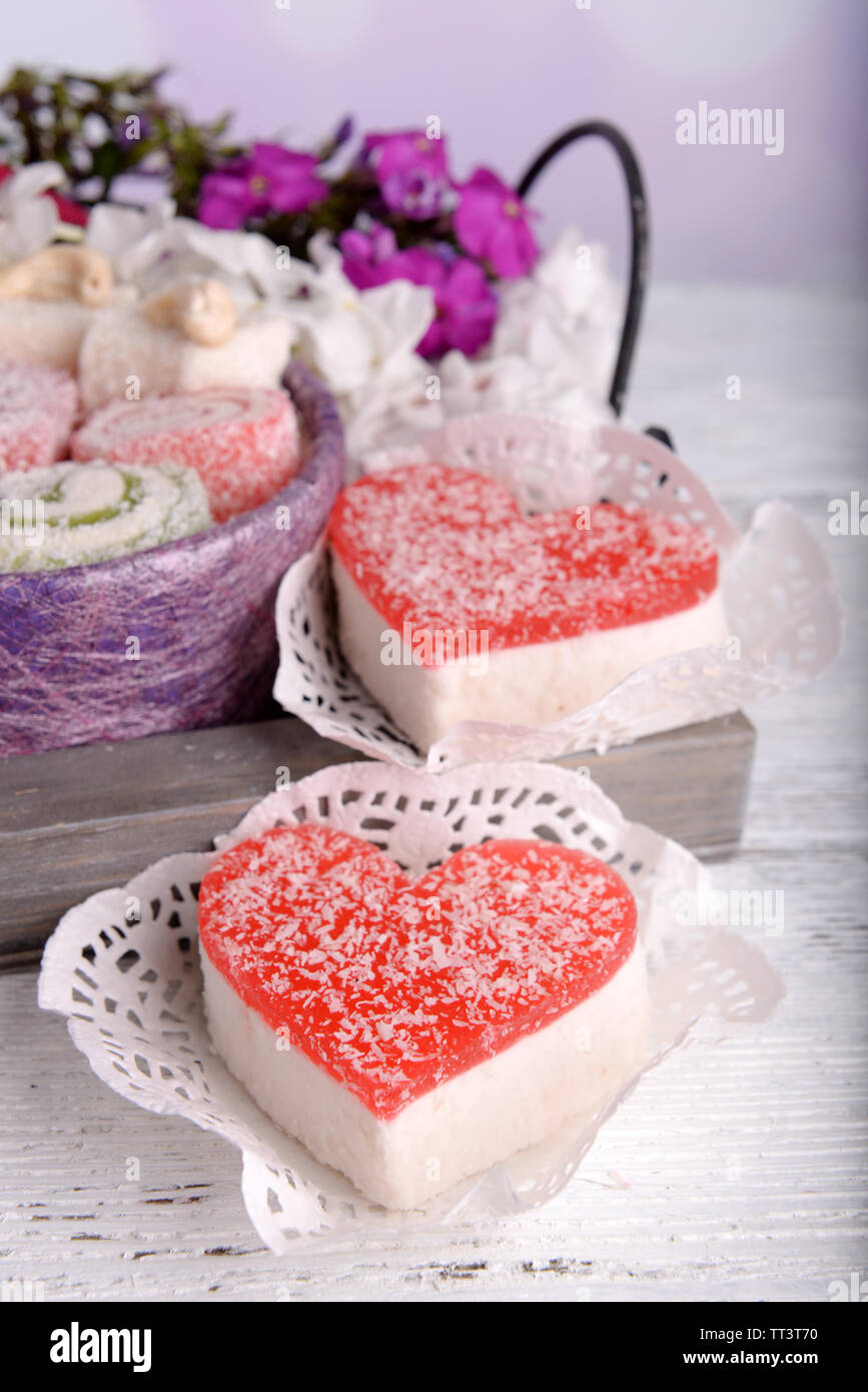 Sweets with flowers on wooden background Stock Photo - Alamy