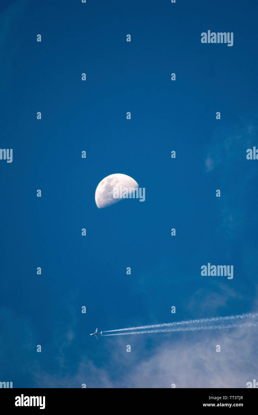 Moon in Daylight with Aircraft Stock Photo - Alamy