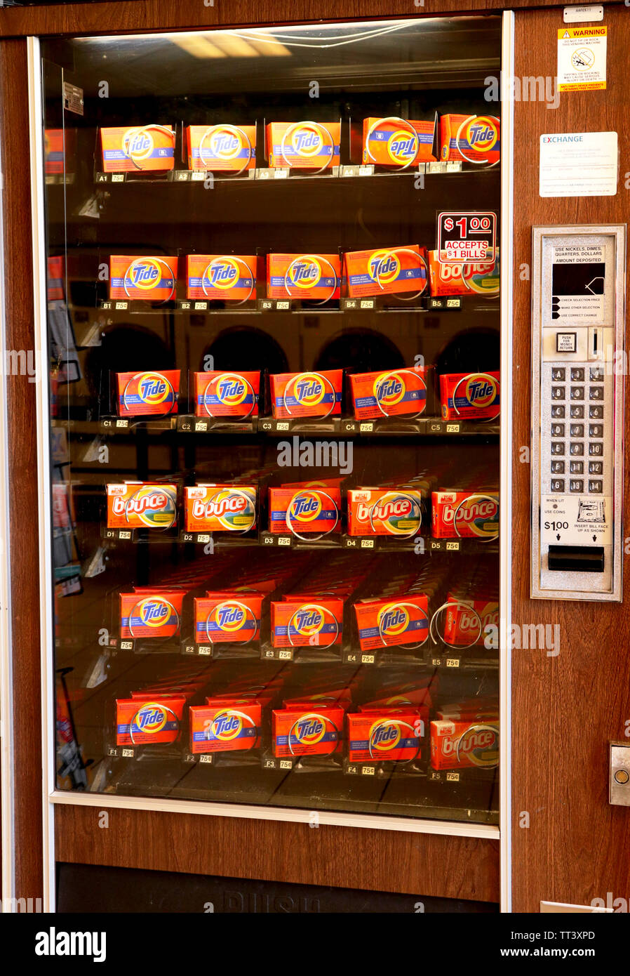 A vending machine in a laundromat selling fabric softener and dryer ...