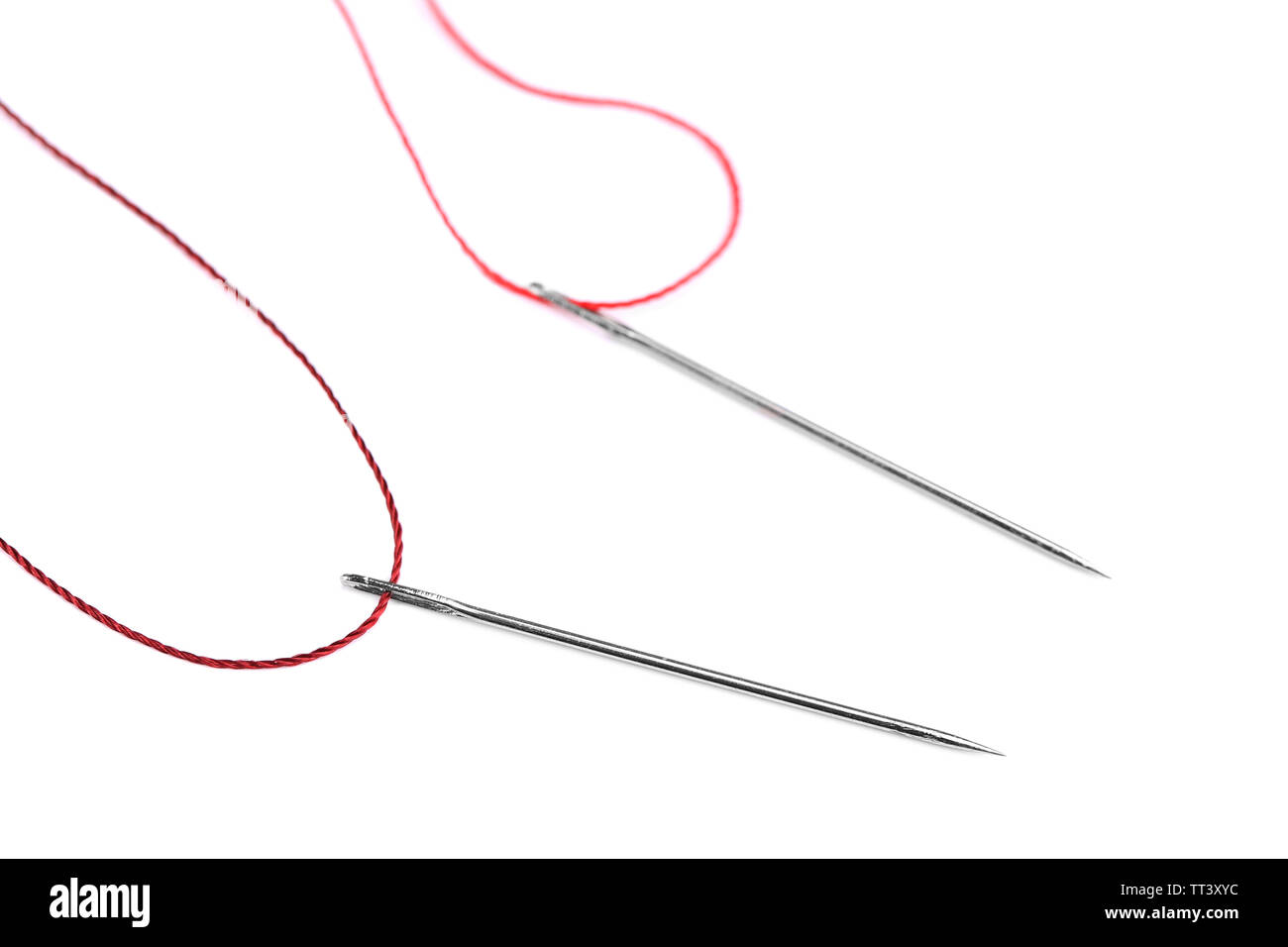Needles and thread isolated on white Stock Photo - Alamy