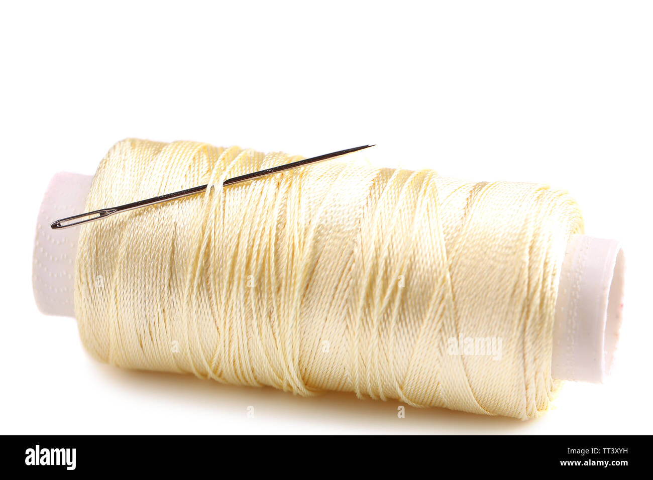 Needle and spool of thread isolated on white Stock Photo - Alamy
