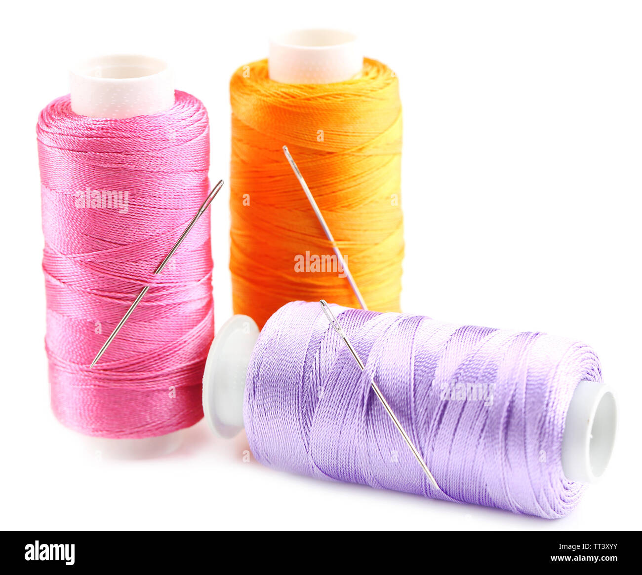 Needles and spools of thread isolated on white Stock Photo - Alamy