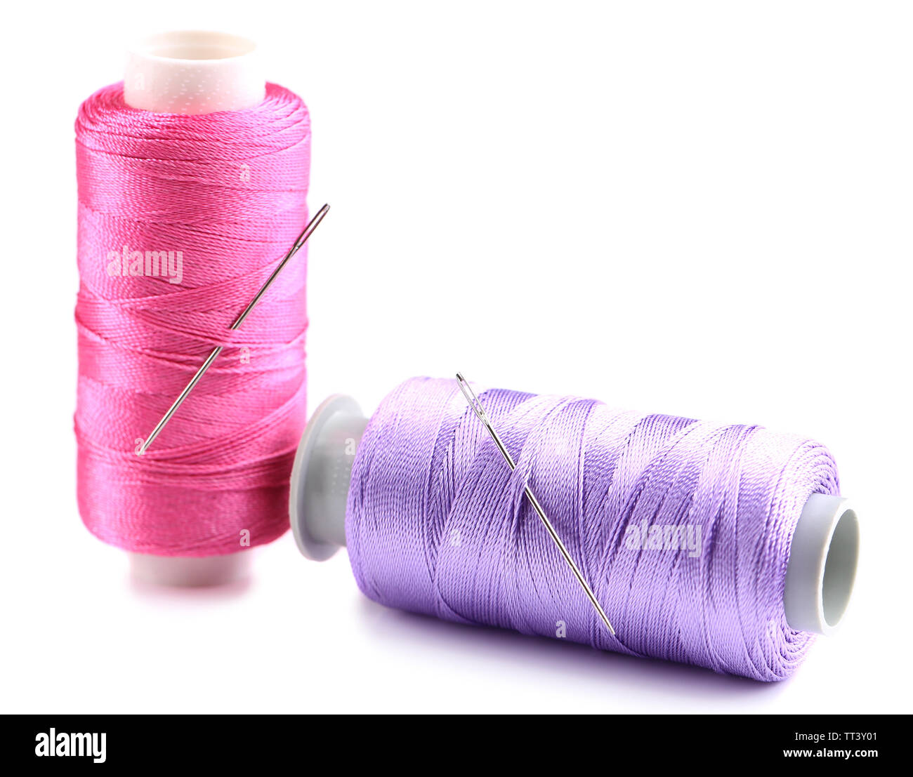 Needles and spools of thread isolated on white Stock Photo - Alamy