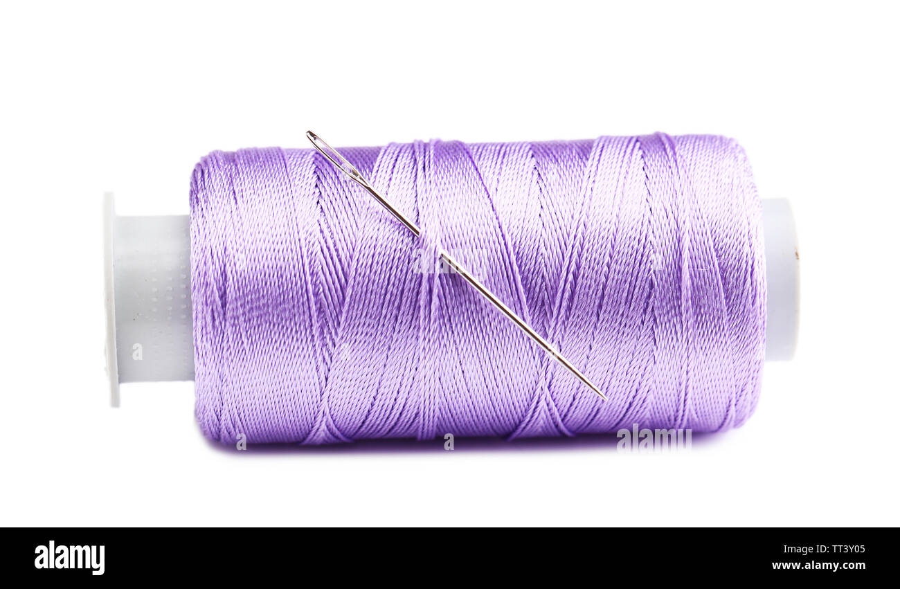 Needle and spool of thread isolated on white Stock Photo - Alamy