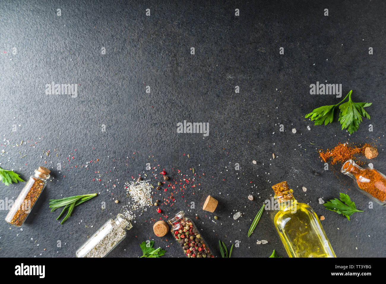 Cooking food background with herbs, olive oil and spices, black stone ...