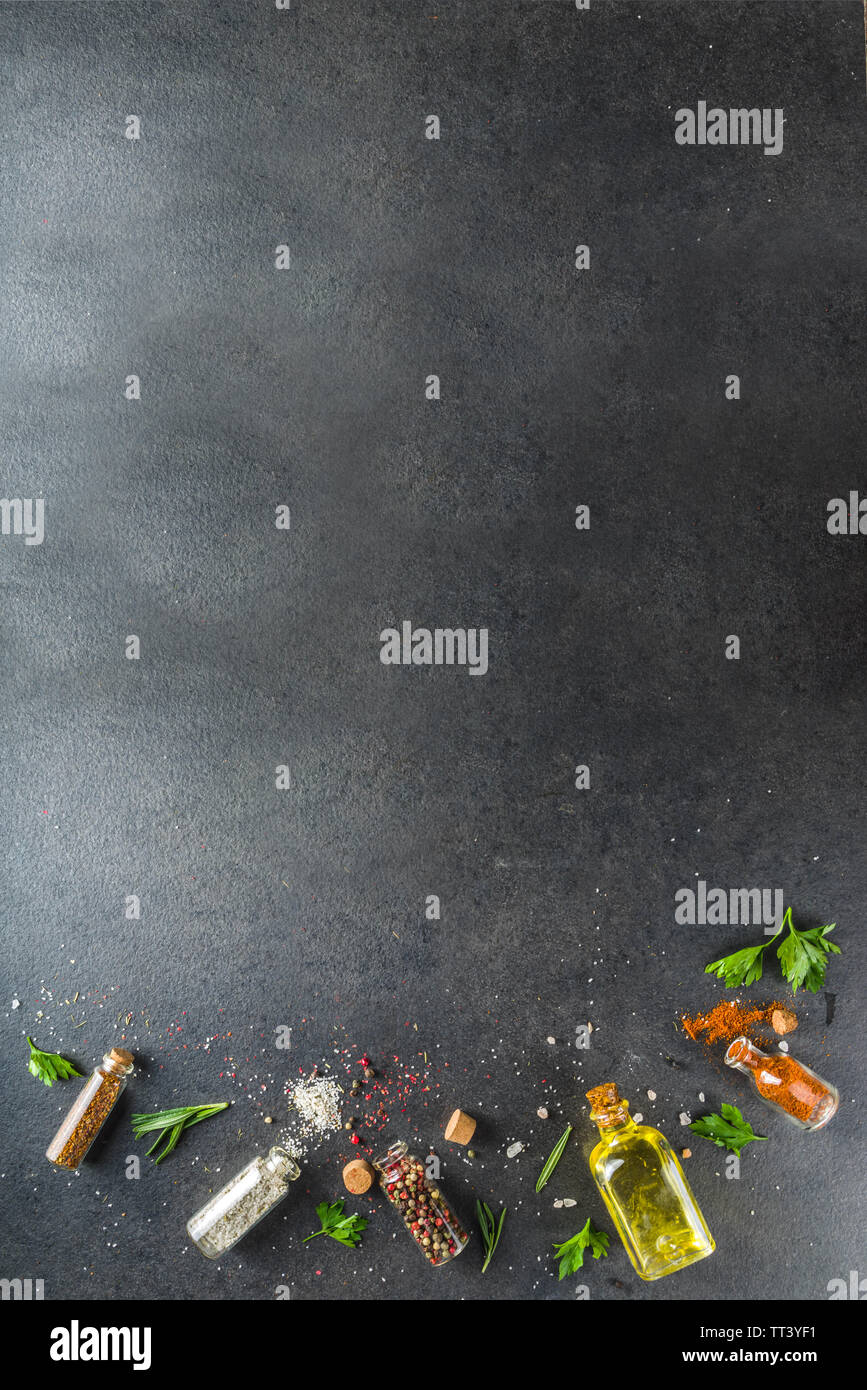 Cooking food background with herbs, olive oil and spices, black stone ...