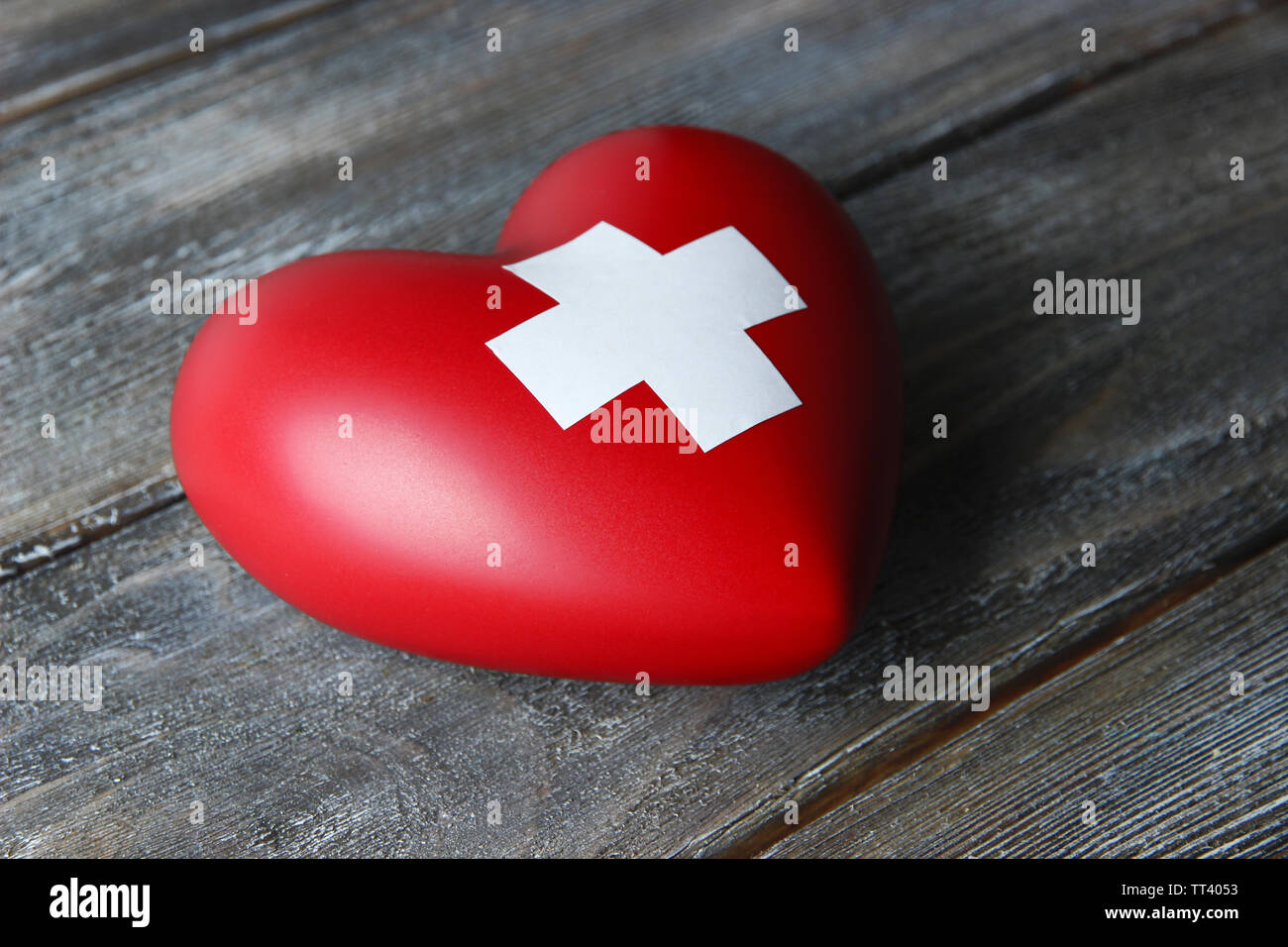 Red heart with cross sign on wooden background Stock Photo - Alamy