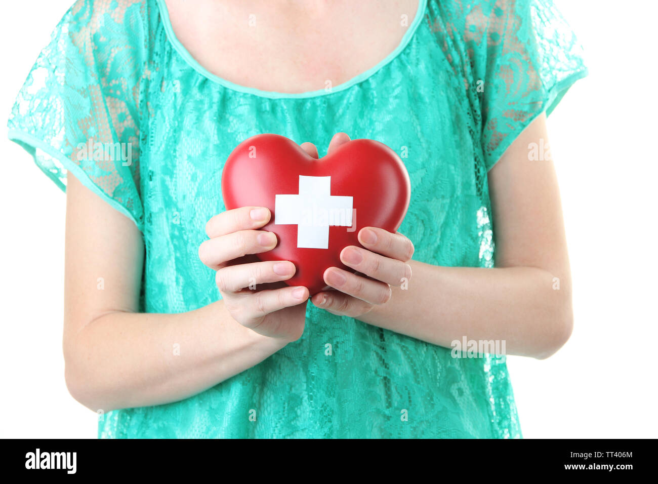 Red heart with cross sign in female hand, close-up, isolated on white ...