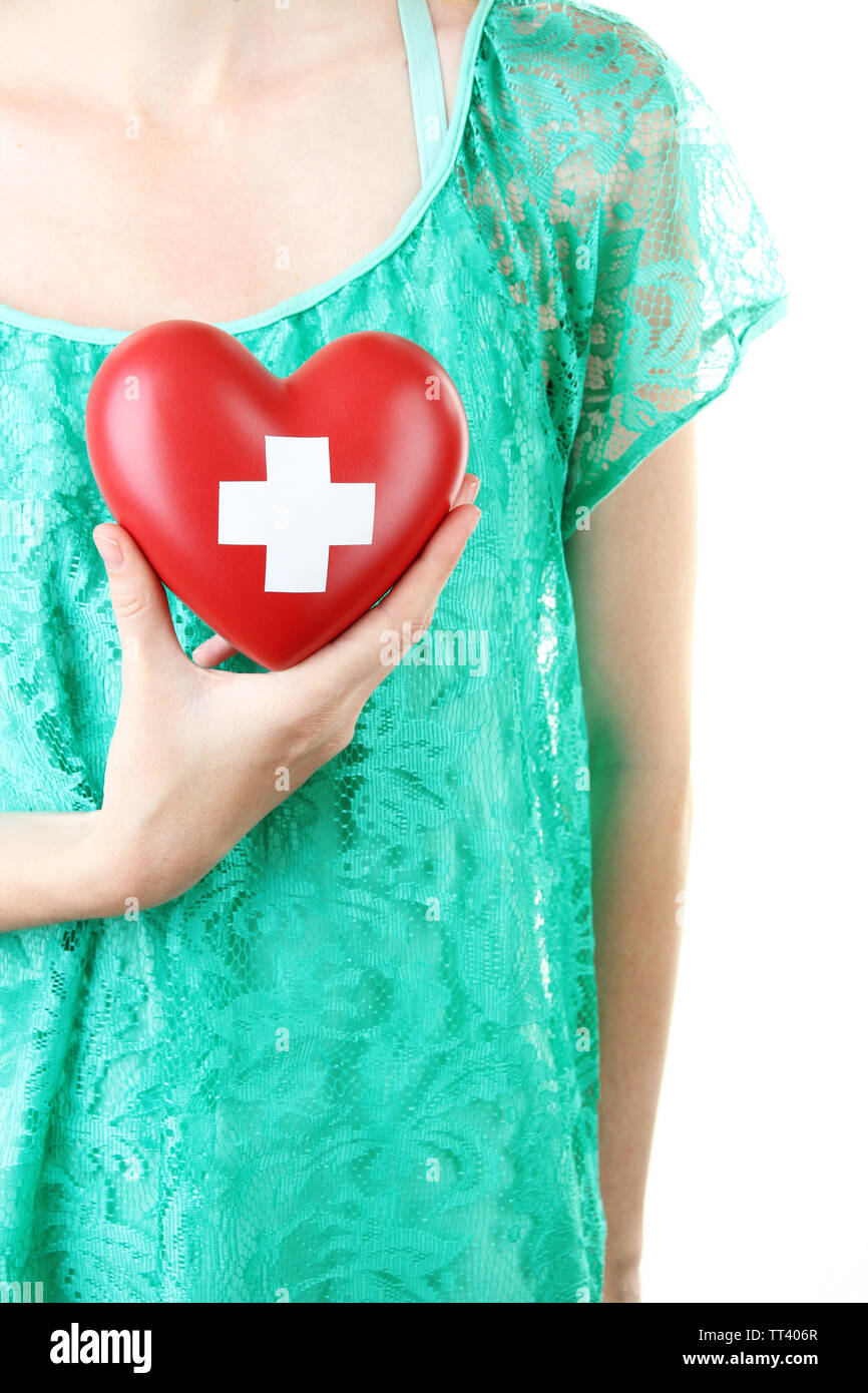 Red heart with cross sign in female hand, close-up, isolated on white ...