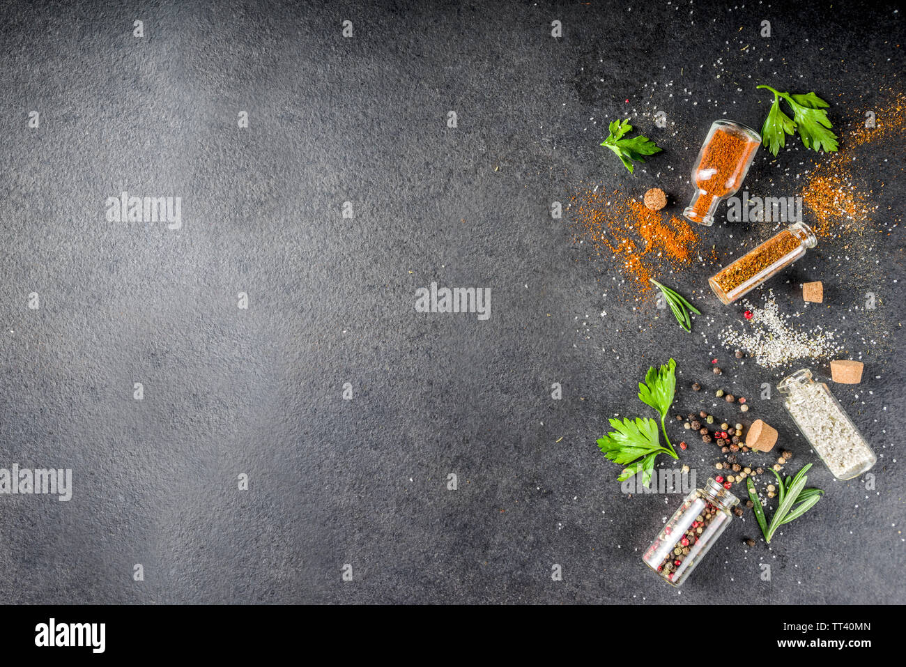 Cooking food background with herbs, olive oil and spices, black stone ...