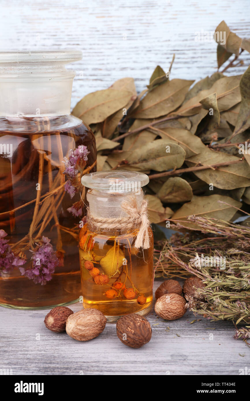 Bottles of herbal tincture and dried leaves on wooden background Stock ...