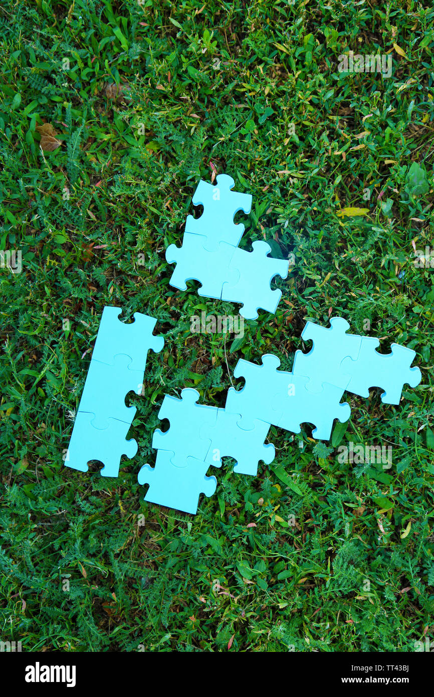 Puzzle pieces on green grass background. Green space concept Stock ...