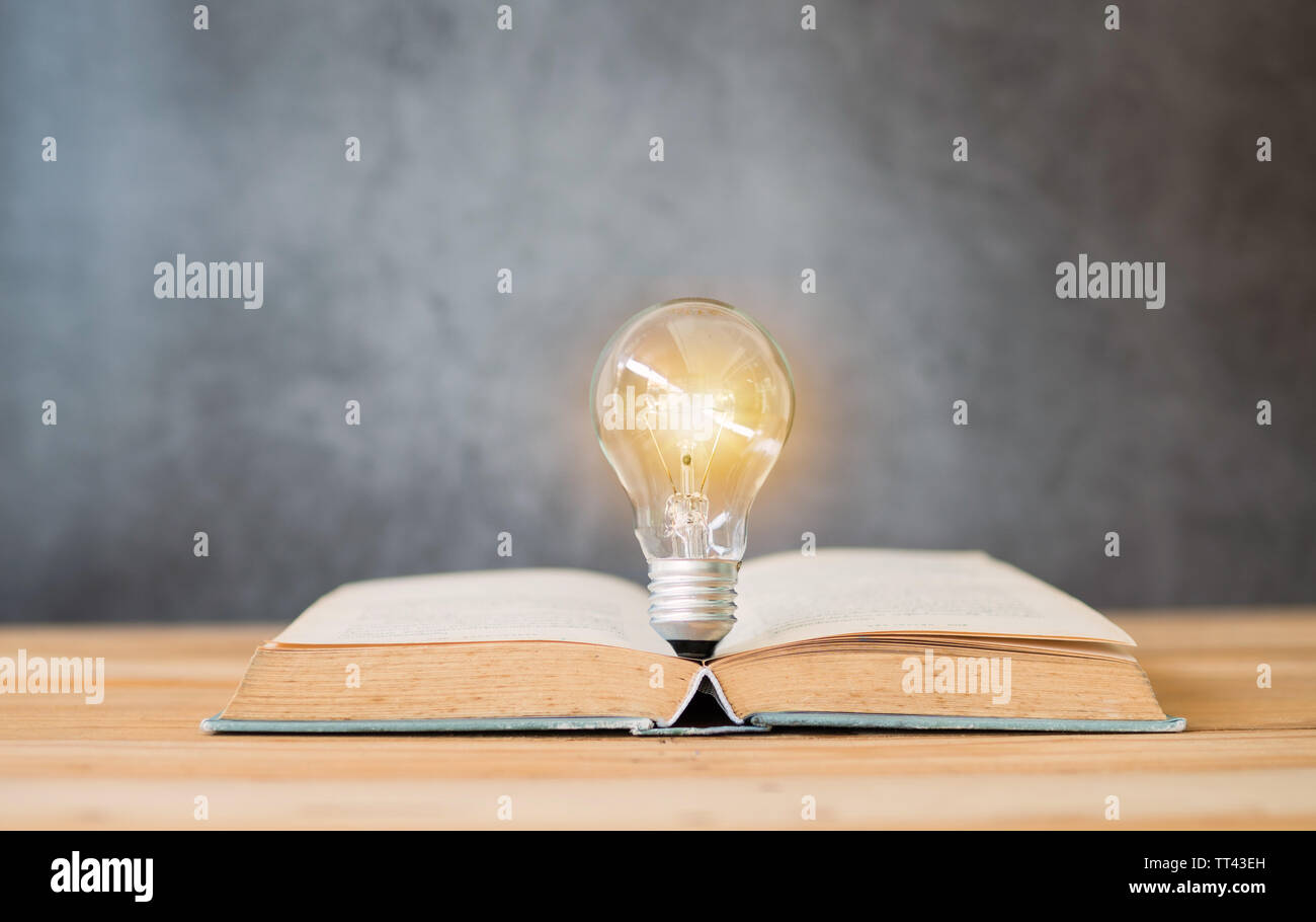 knowledge and wisdom, light bulb on book Stock Photo - Alamy
