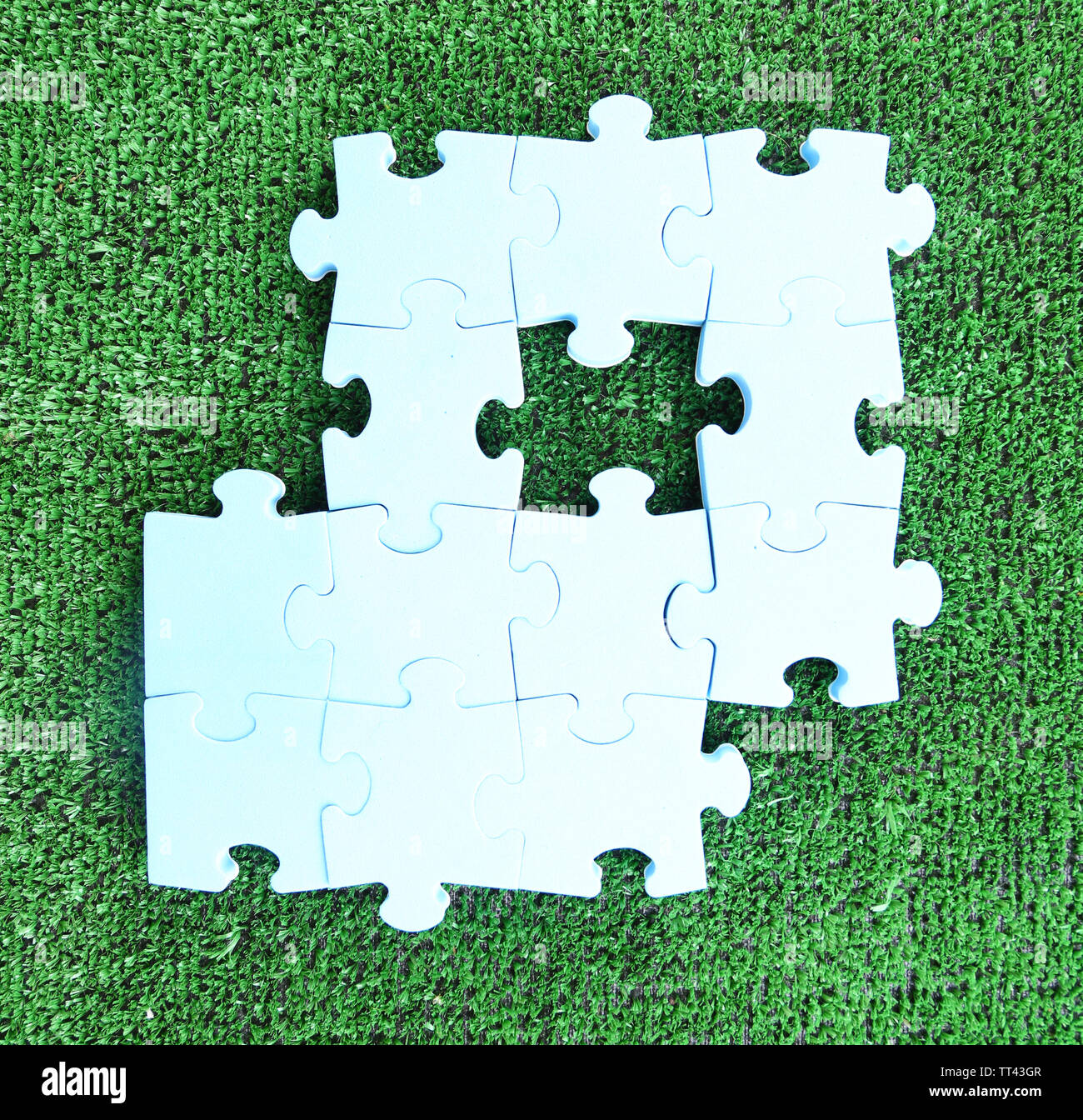 Puzzle pieces on green grass background. Green space concept Stock ...