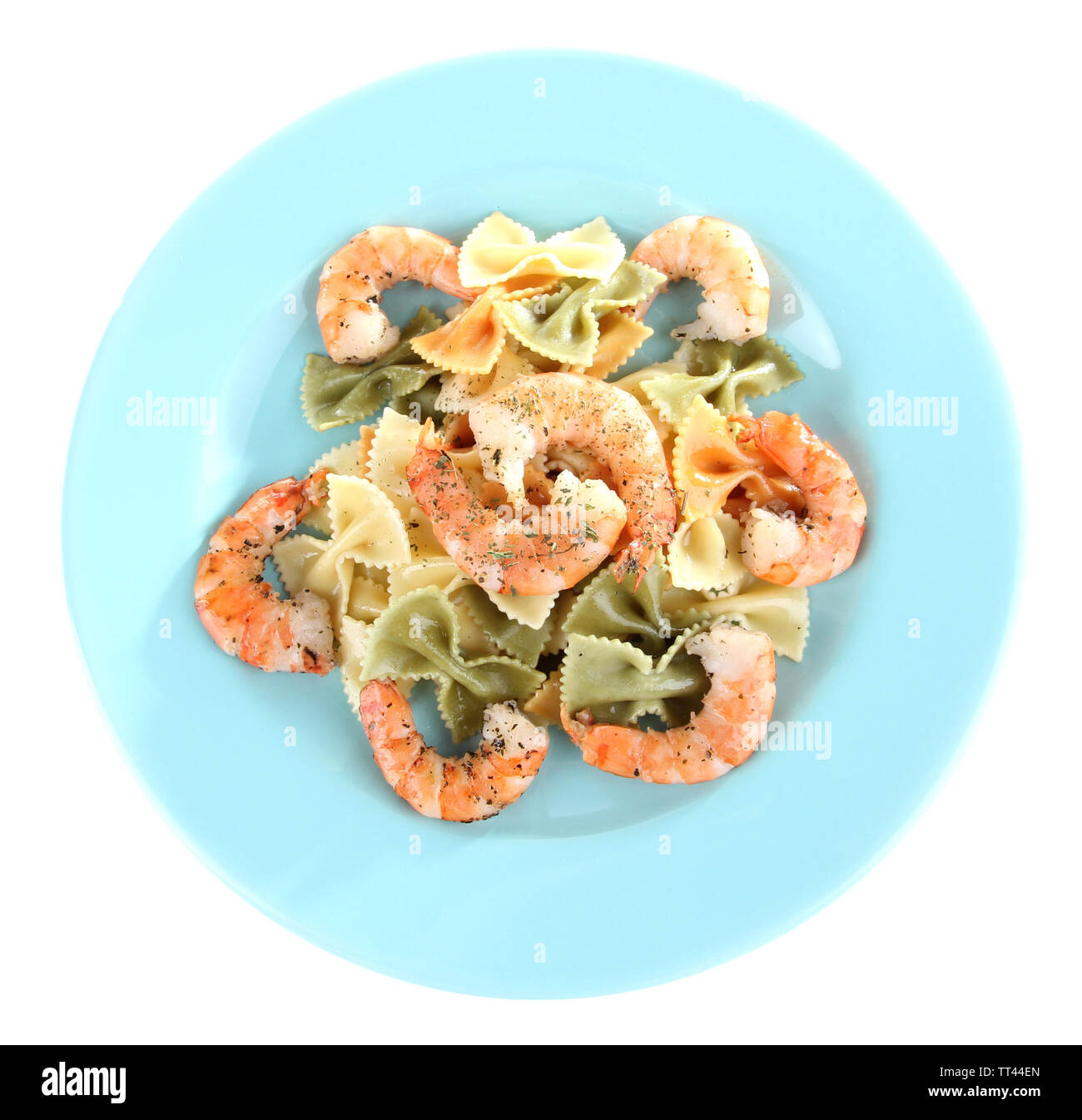 Fresh prawns with coloured macaroni in a big blue plate on white ...