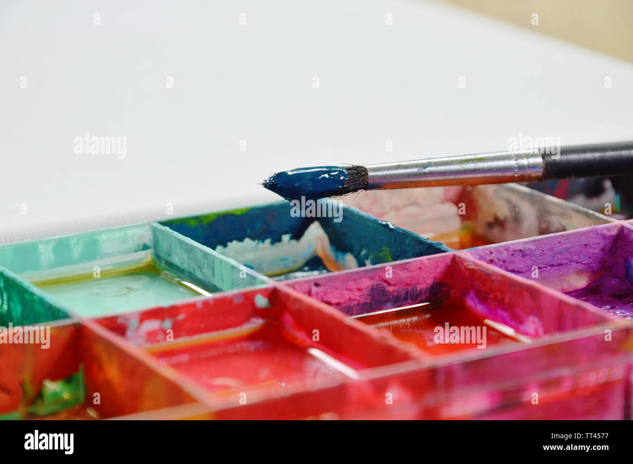 paint brush and oil color with white canvas frame Stock Photo - Alamy