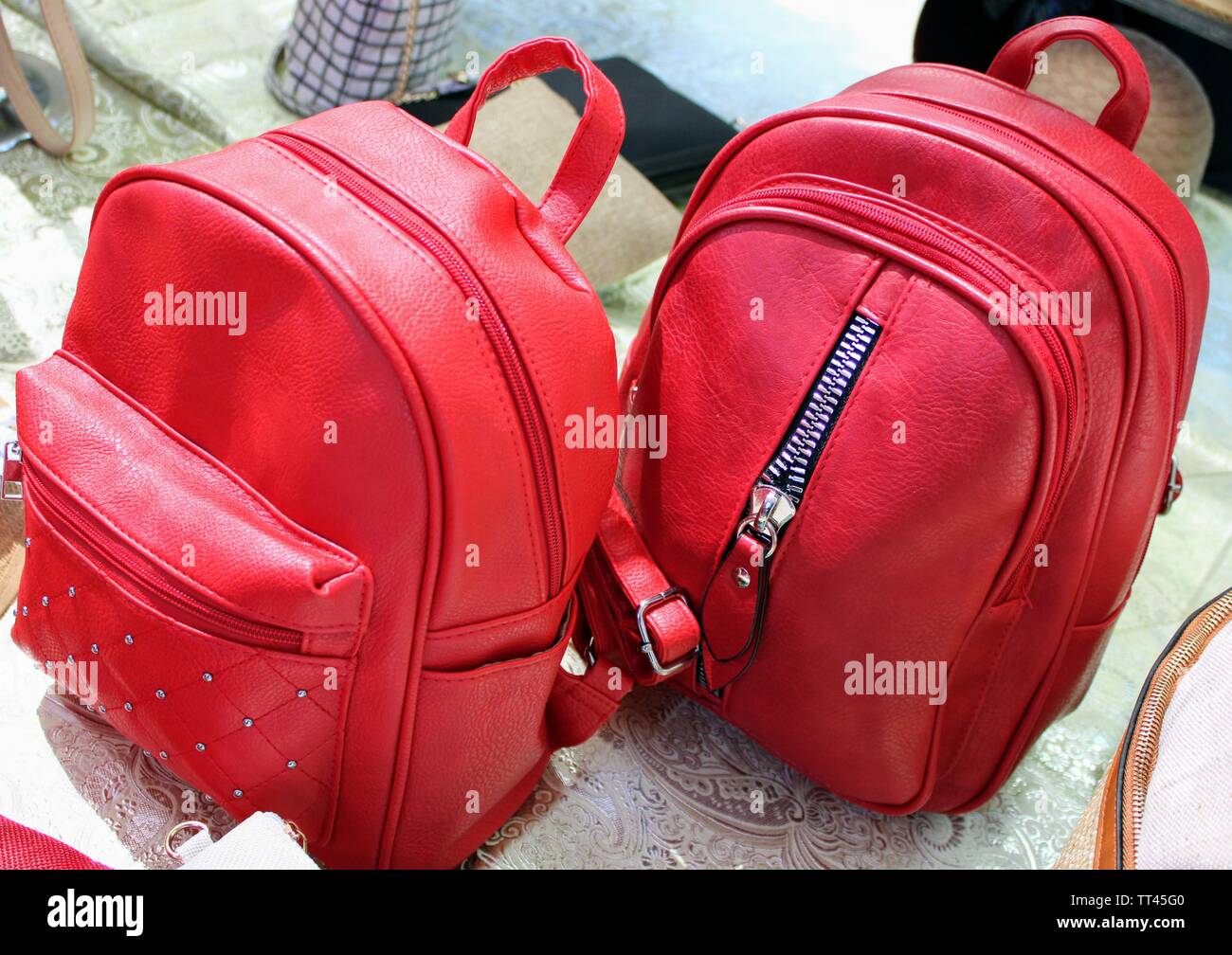 Beautiful red leather backpacks with zippers and different models Stock ...