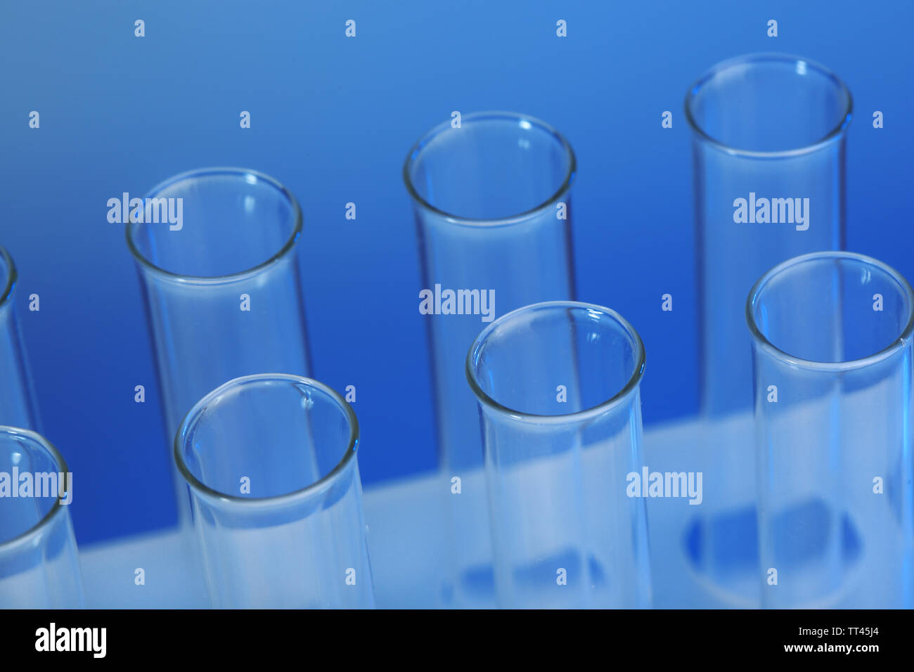 Empty test-tubes on blue background closeup Stock Photo - Alamy