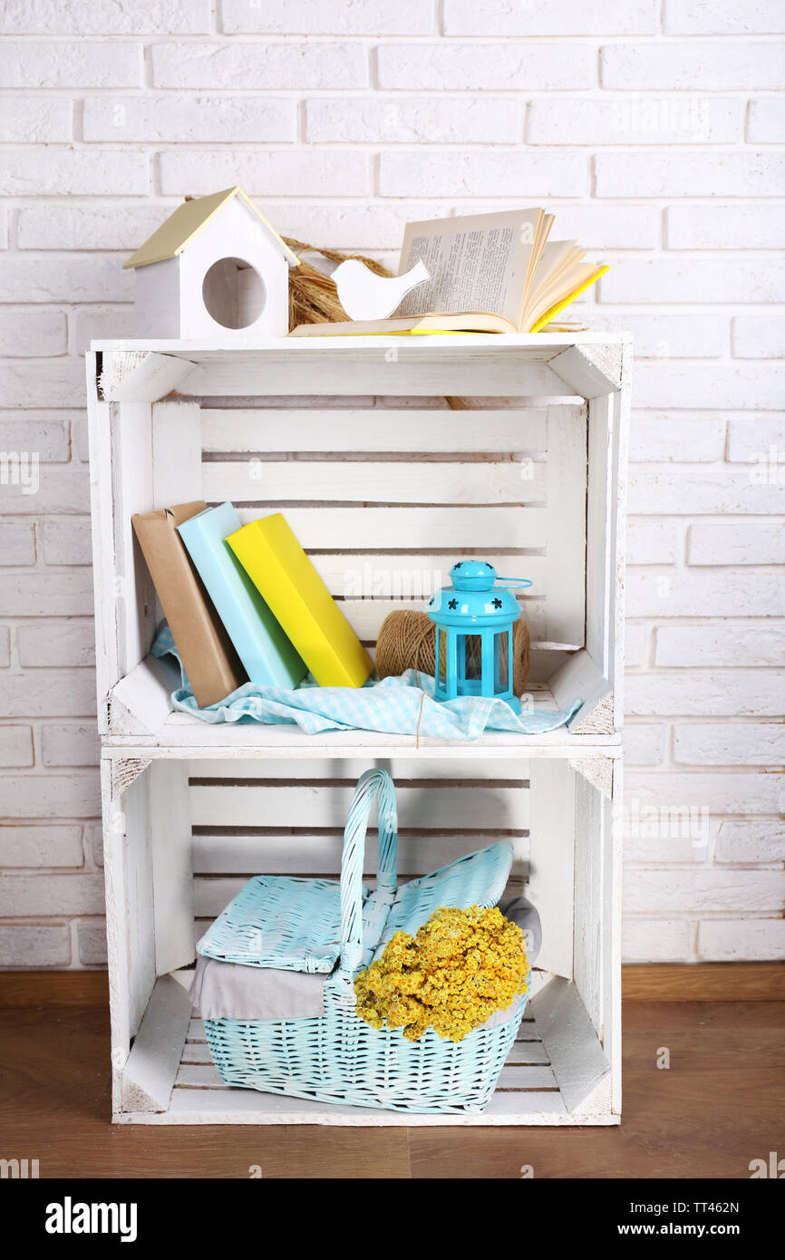 Wooden boxes with home things on white brick wall background Stock ...