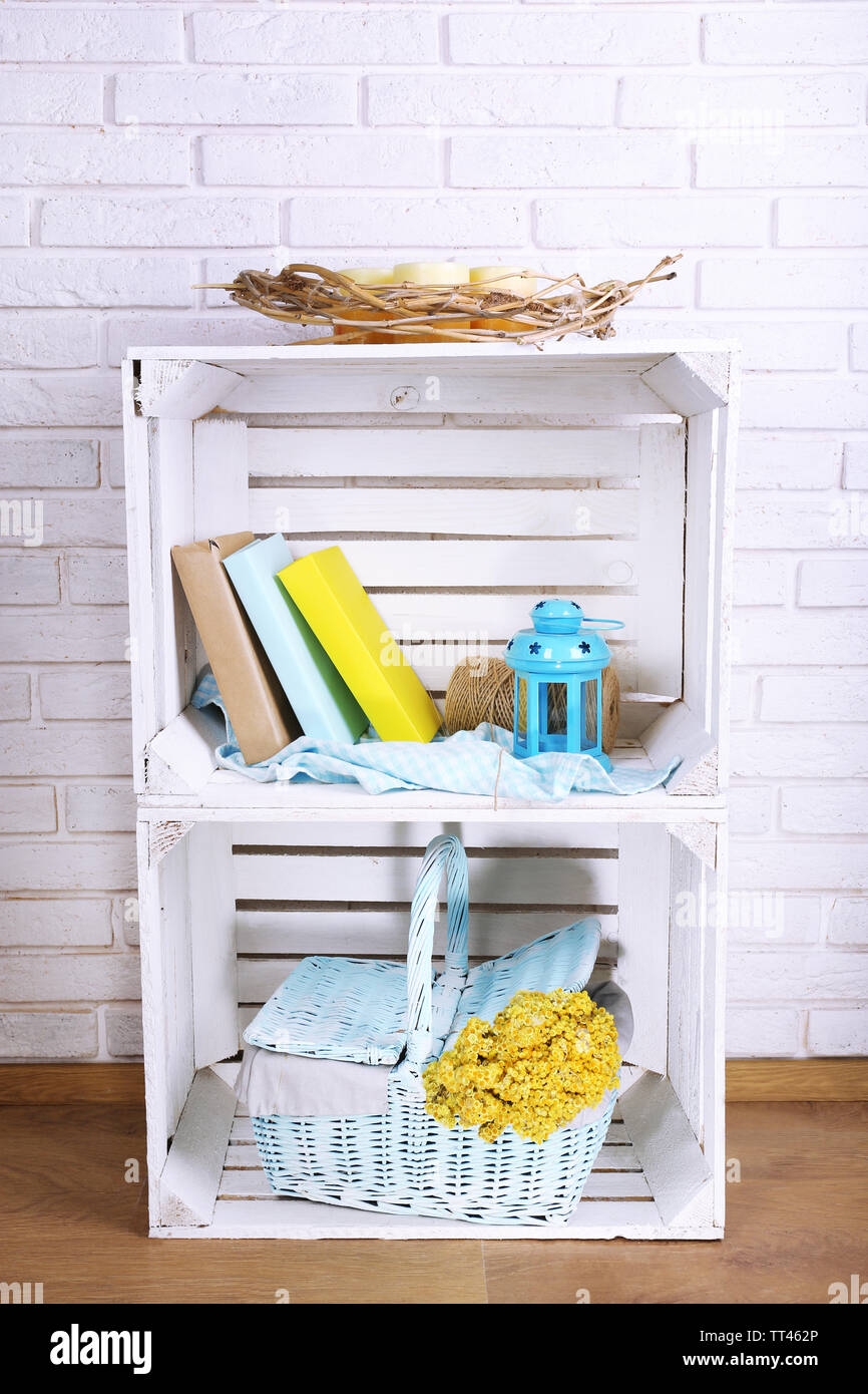 Wooden boxes with home things on white brick wall background Stock ...