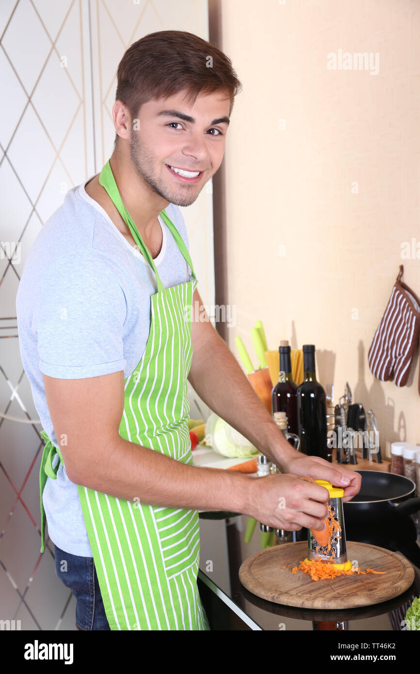 Handsome man cooking in kitchen at home Stock Photo - Alamy