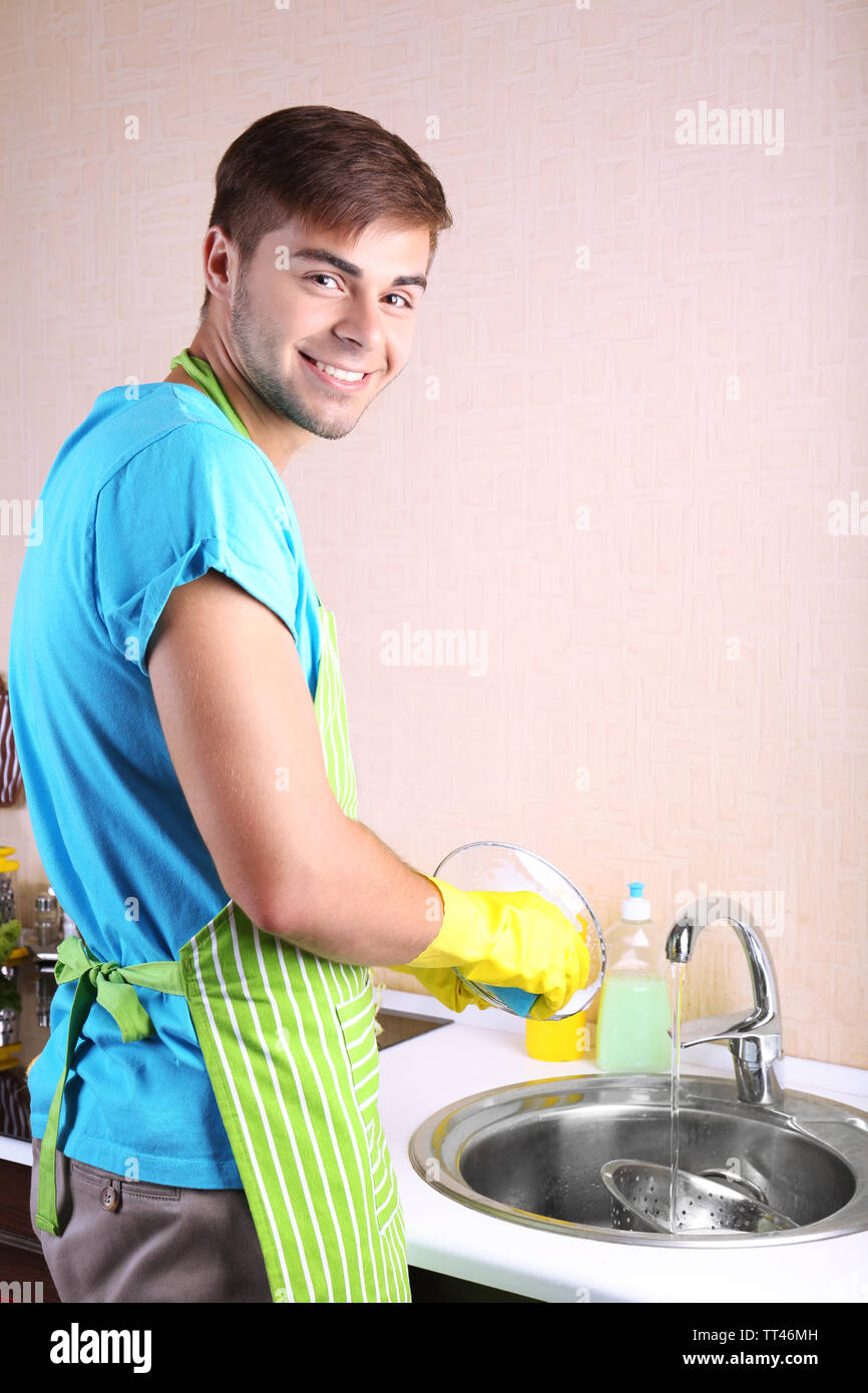 Man washing dish in kitchen Stock Photo - Alamy