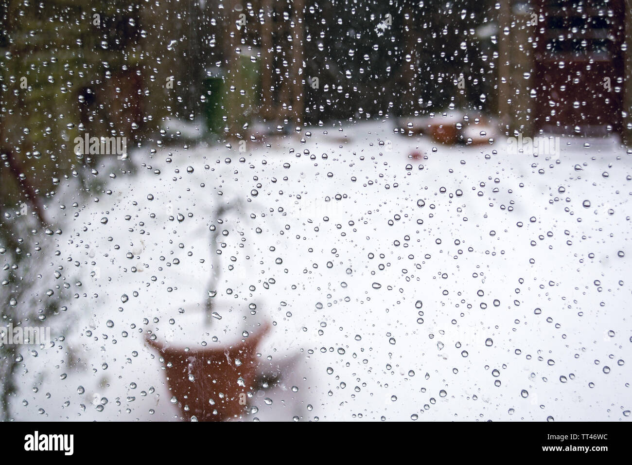 Raindrops on glass under snow shower 4 Stock Photo - Alamy