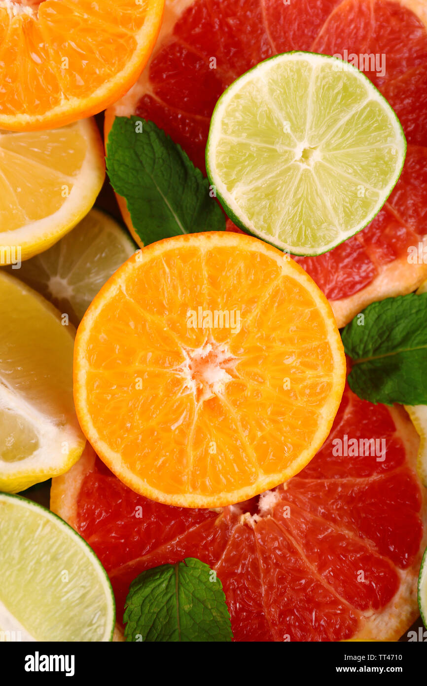 Different sliced juicy citrus fruits, close up Stock Photo - Alamy