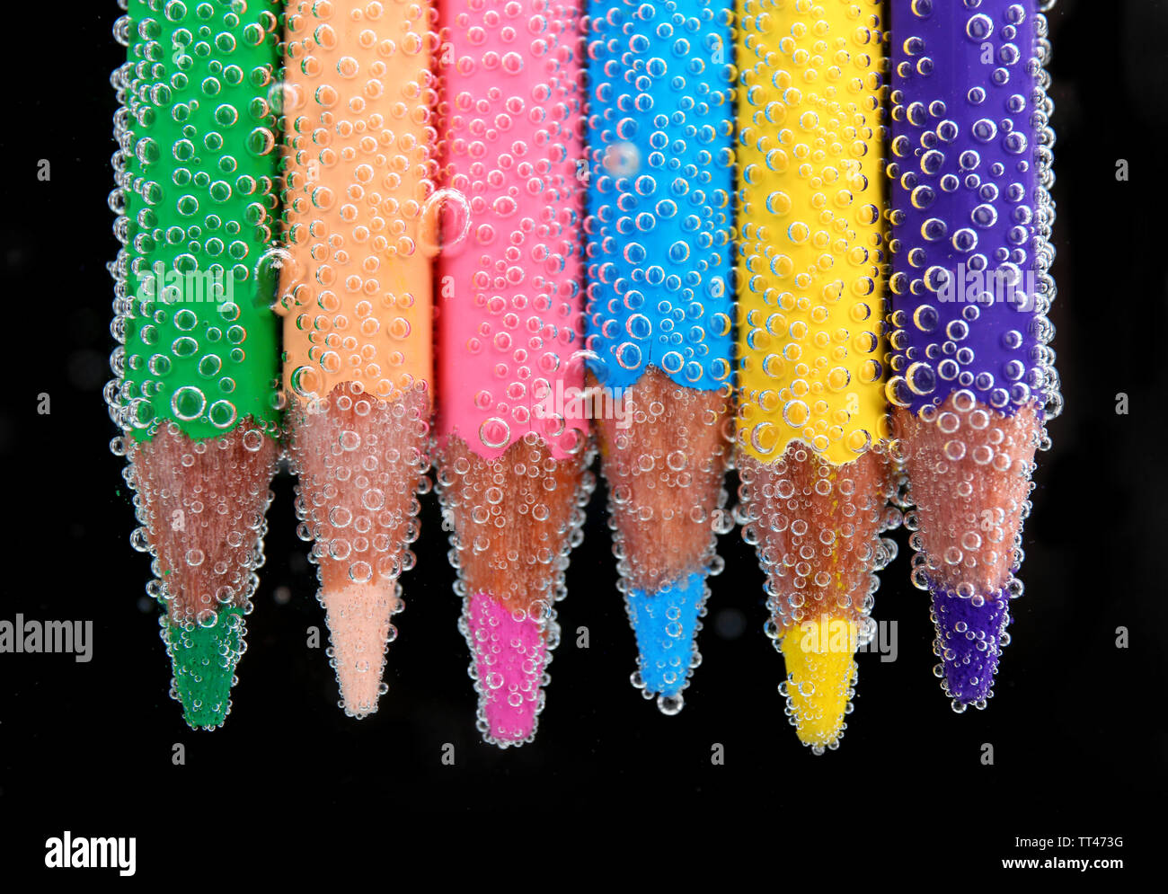 Colorful pencils in water with bubbles on black background Stock Photo ...