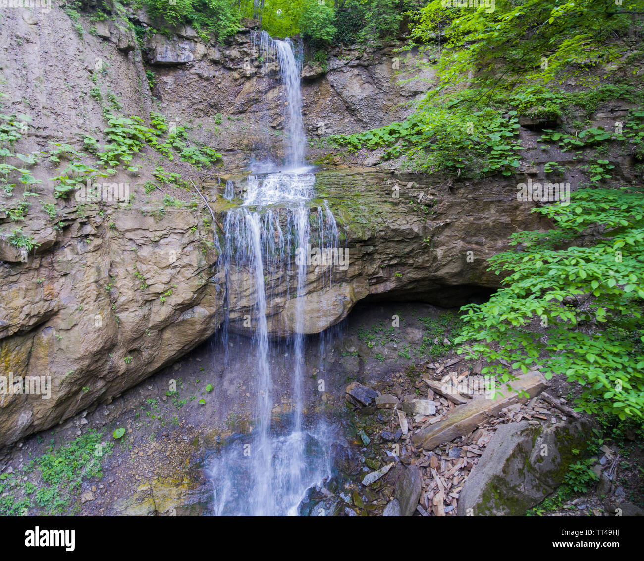 Stream mountain waterfall cascading from the cliff. Aerial view. Drone ...