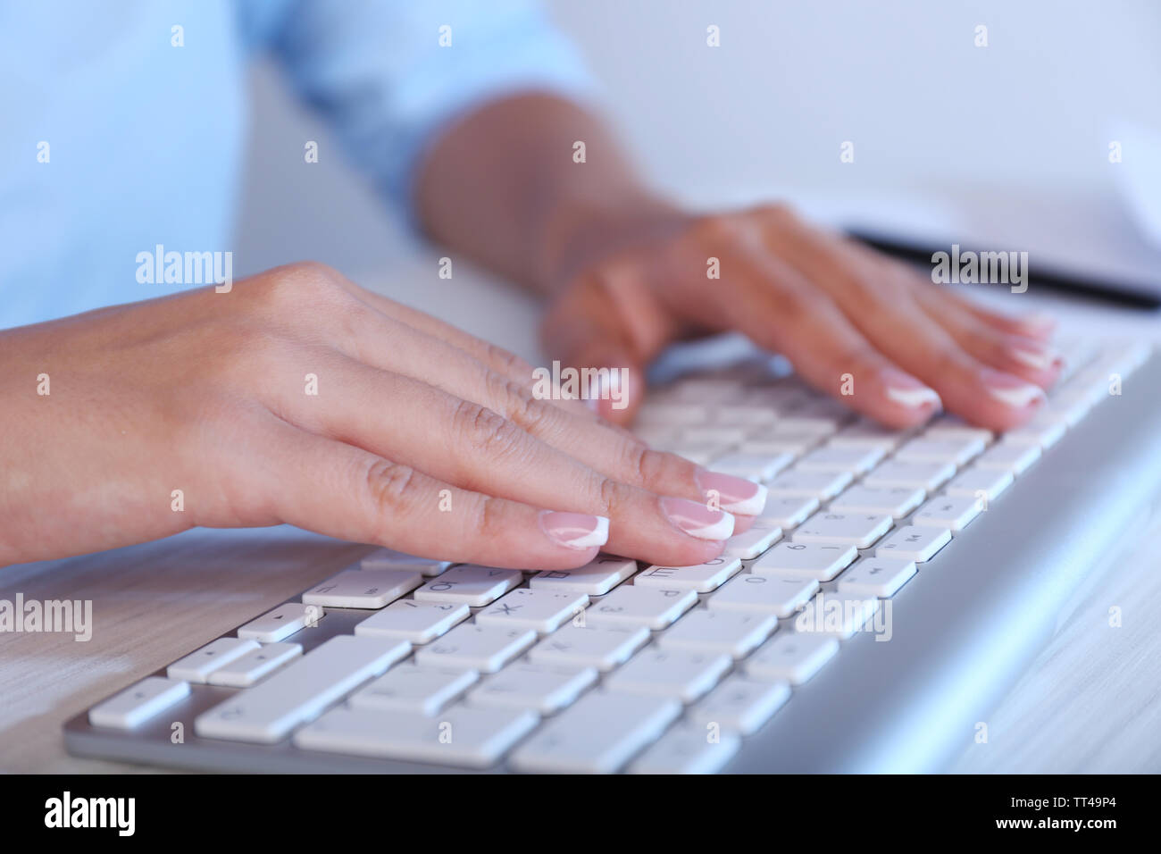 Female hands typing on keyboard, close-up, on dark background Stock ...