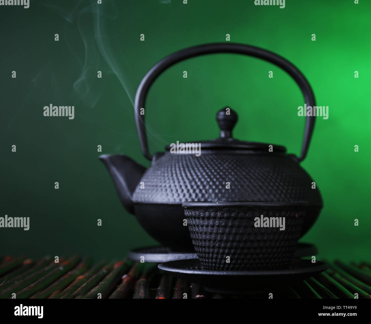 Chinese traditional teapot on bamboo mat, on dark color background ...