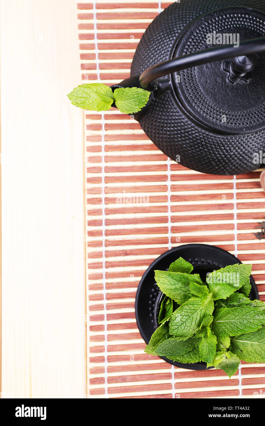 Chinese traditional teapot with fresh mint leaves on wooden background ...