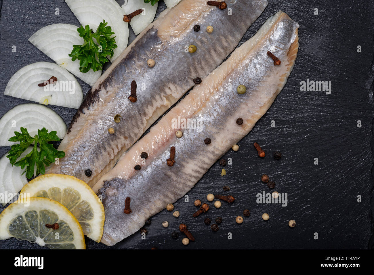 Salted Deboned Herring Fillets garnished with Yellow Onion, Lemon ...