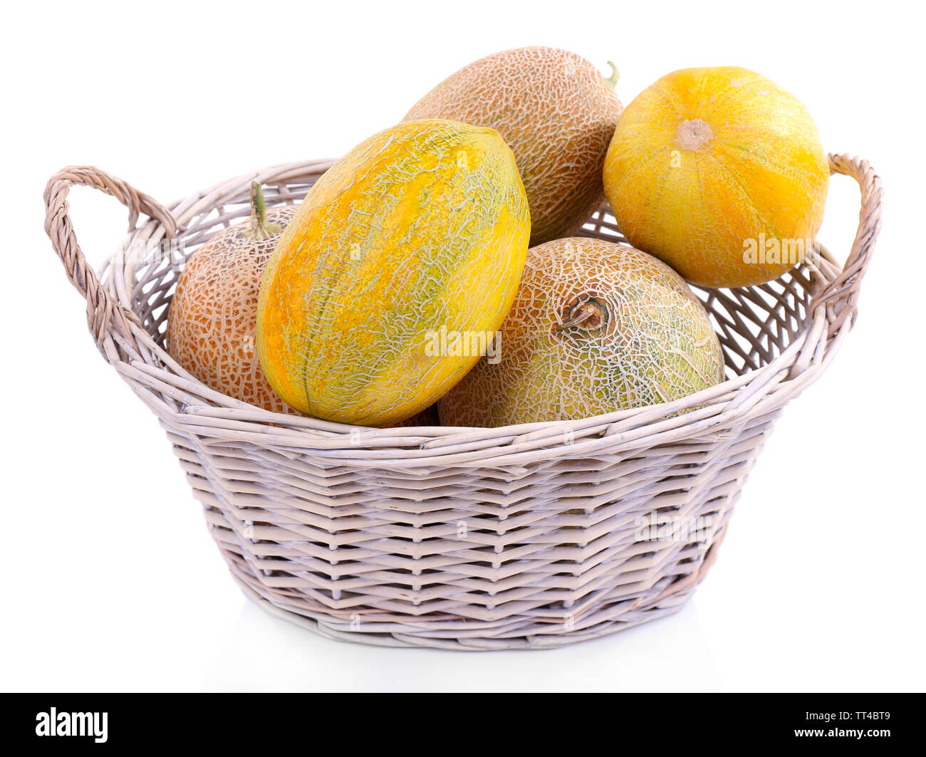 Melons in basket isolated on white Stock Photo - Alamy