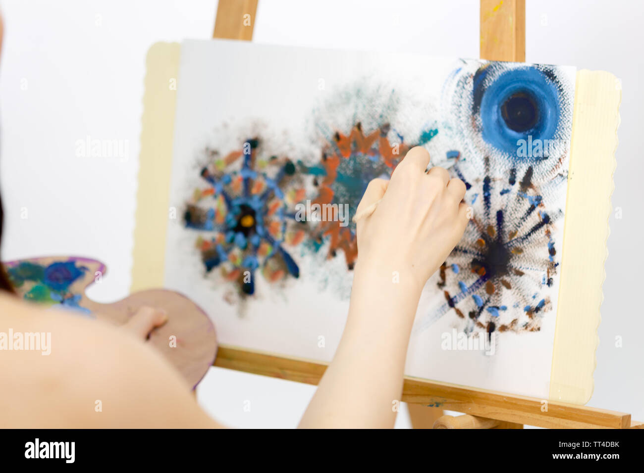 Anonymous artist painting on an easel Stock Photo - Alamy