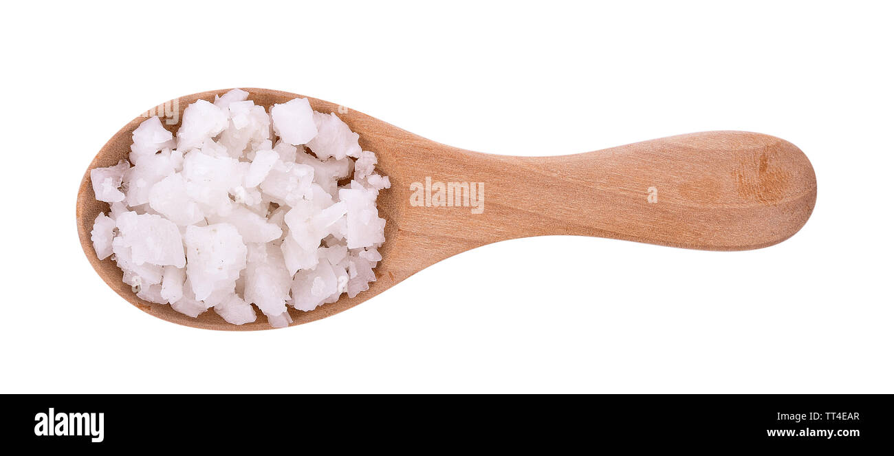 Sea salt in spoon on white background Stock Photo - Alamy