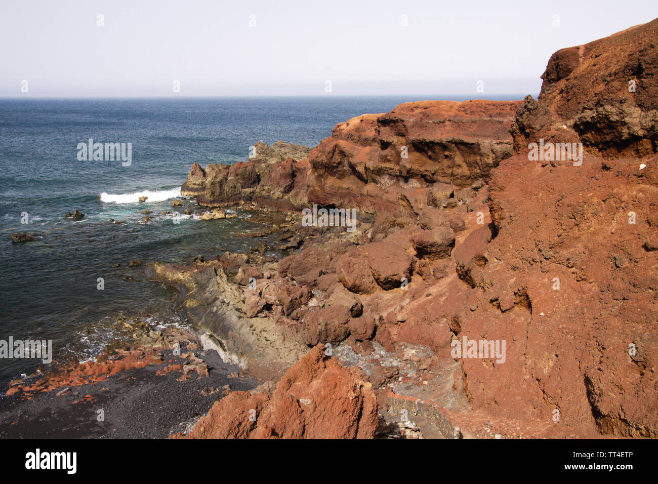 View on secluded lagoon surrounded by impressive rugged weathered ...