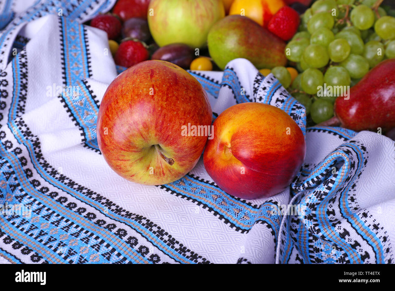 Different berries and fruits on fabric close-up background Stock Photo ...