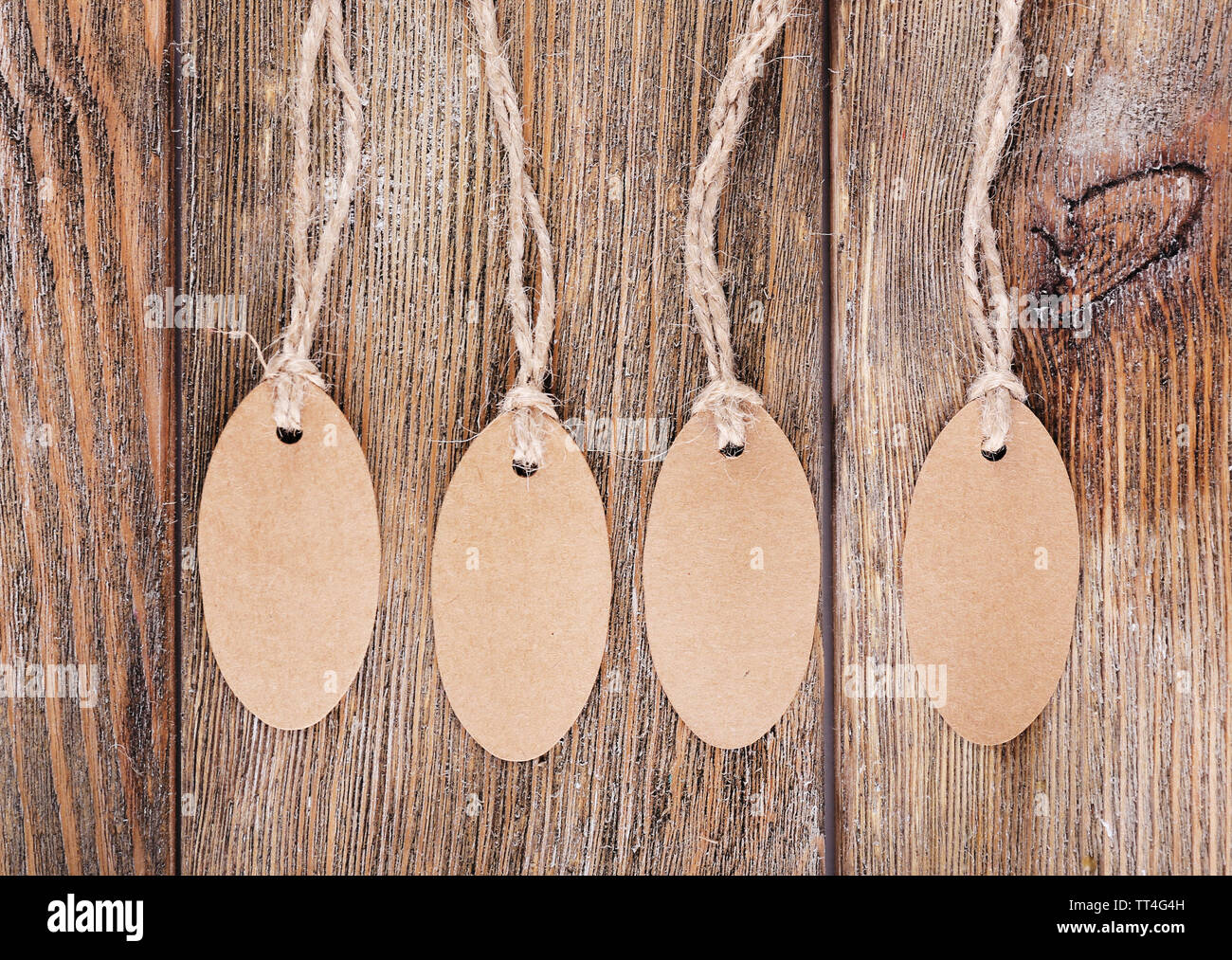 Brown tags on wooden background Stock Photo - Alamy