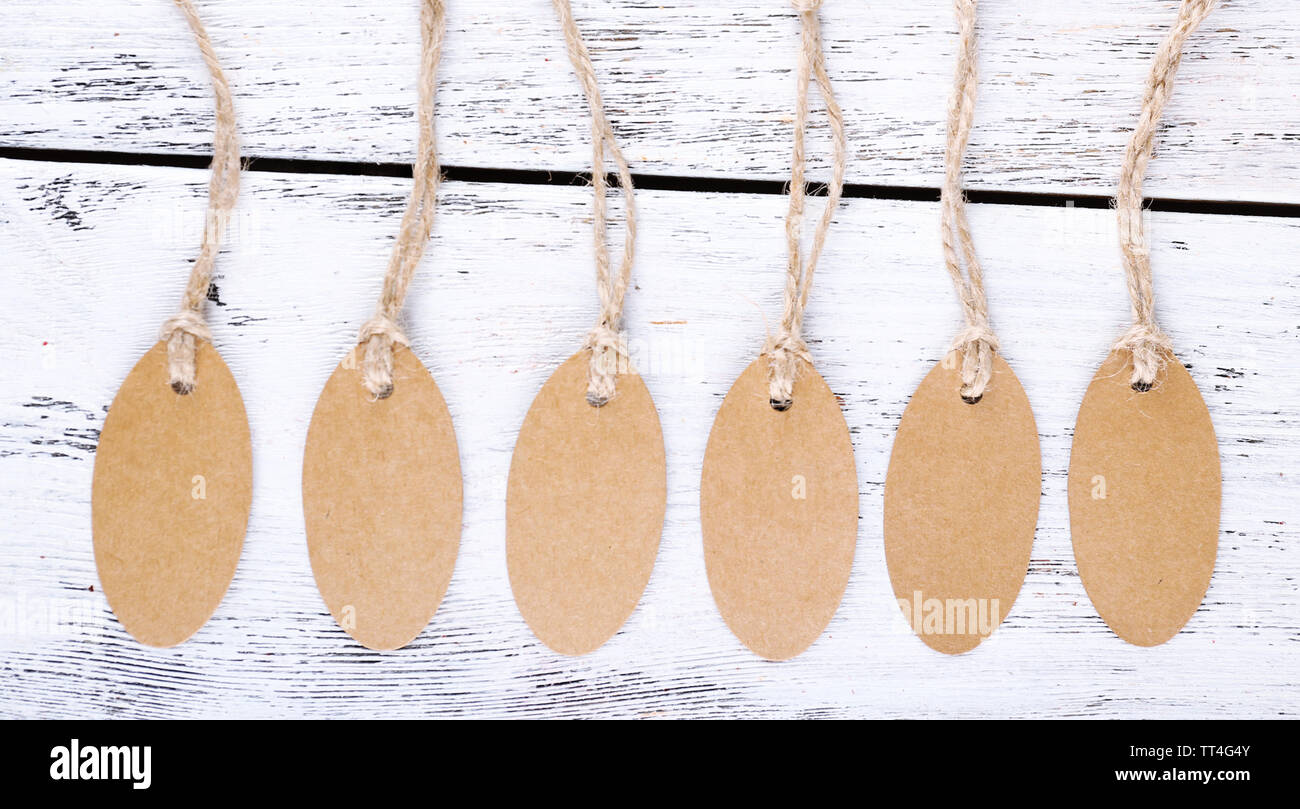 Brown tags on wooden background Stock Photo - Alamy